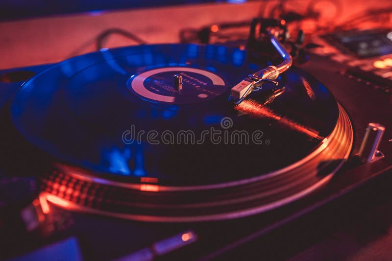 Vinyl Record on the Turntable in the Music Club in the Light of Blue ...