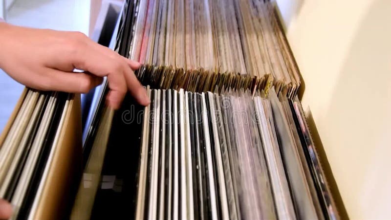 Picking a Vinyl Record from a Shelf Stock Footage - Video of happiness ...