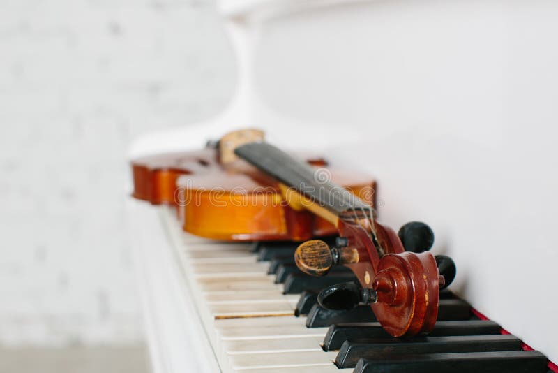 The Violin and Keyboard of White Piano Stock Photo - Image of keyboard ...