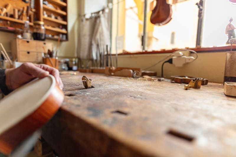 Luthier Carving the Shape of the Outside of the Front of a Violin with ...