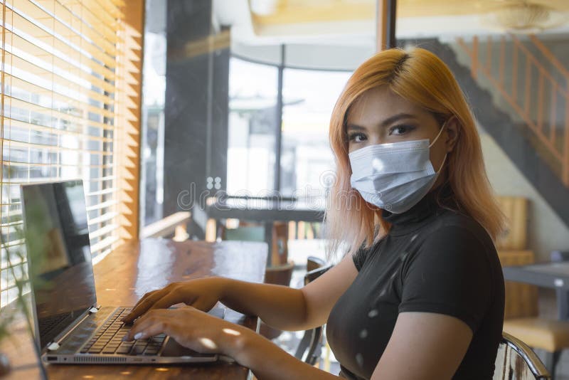 A Virtual Assistant with a Face Mask Working Remotely at an Uncrowded ...