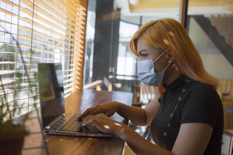 A Virtual Assistant with a Face Mask Working Remotely at an Uncrowded ...