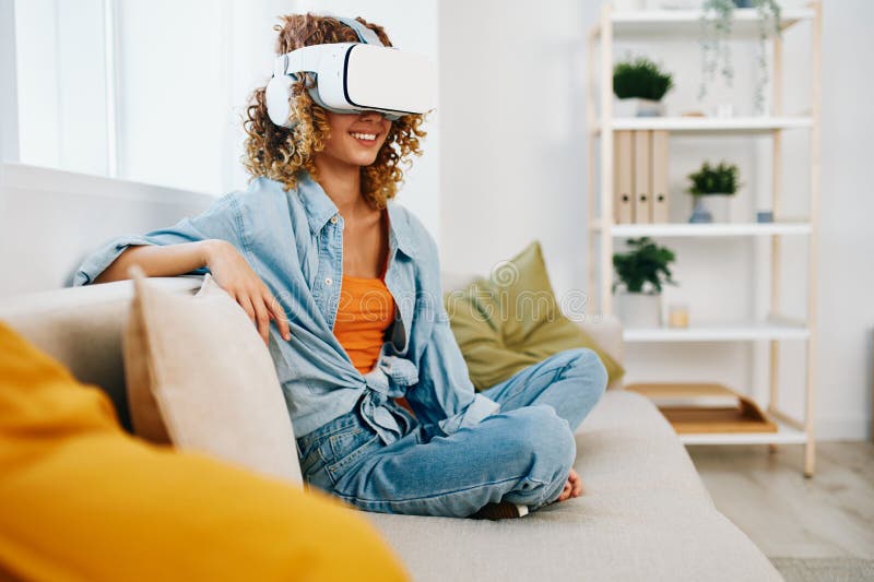 Virtual Reality Fun A Smiling Woman Enjoying A Futuristic Virtual Reality Game At Home Wearing