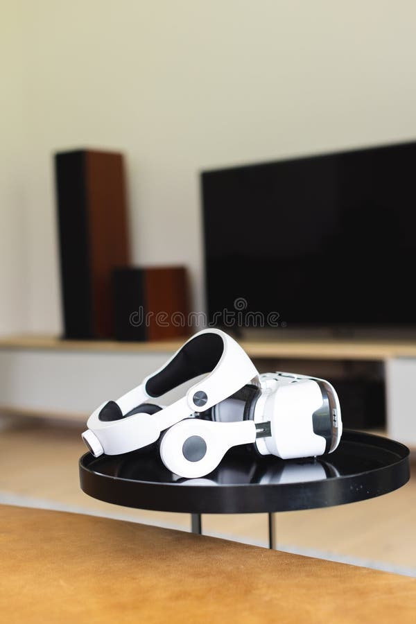 A Virtual Reality Headset Rests on a Table in a Modern Living Room with ...