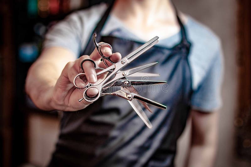 A Virtuoso Barber Holds Four Scissors in One Hand (focus on the ...