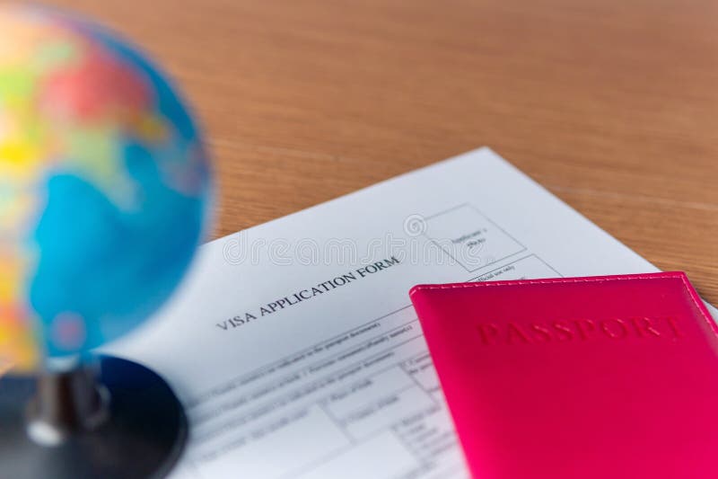 A Visa Application Form, a Red Passport, and a Globe. Stock Photo ...