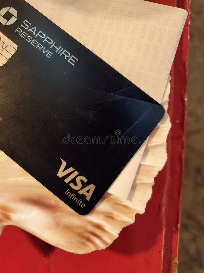 VISA Infinite Sapphire Reserve Card on White Folded Receipt and Red ...