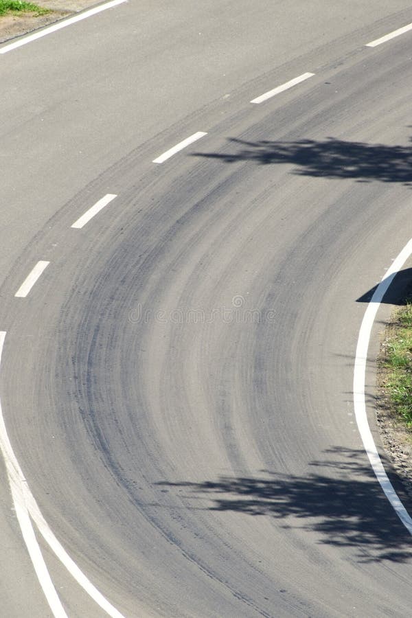 Long Road Curve with Black Tire Tracks Stock Photo - Image of tire ...