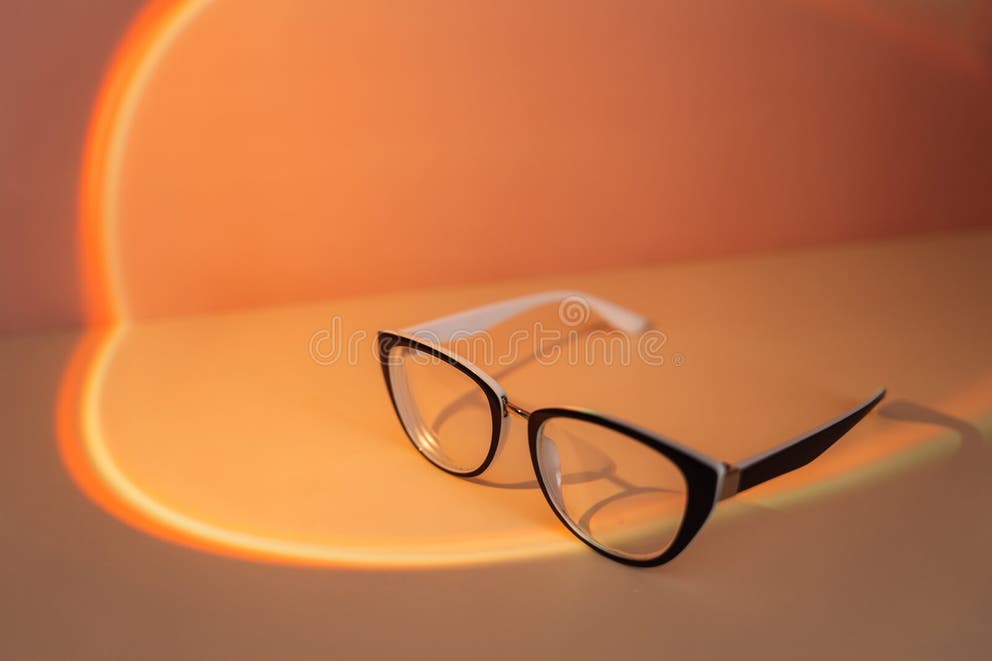 Vision Glasses with Black Frames Under Orange Light Stock Image - Image ...
