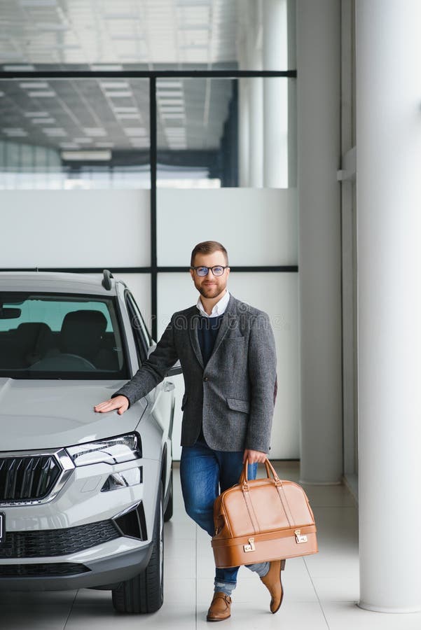 Visiting Car Dealership. Handsome Bearded Man is Stroking His New Car ... Visiting Car Dealership. Handsome Bearded Man is Stroking His New Car ...