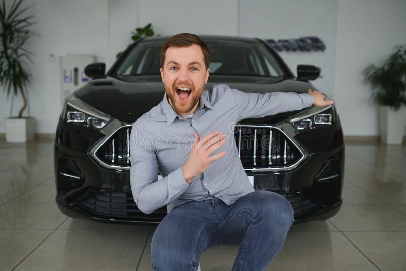 Visiting Car Dealership. Handsome Bearded Man is Stroking His New Car ... Visiting Car Dealership. Handsome Bearded Man is Stroking His New Car ...