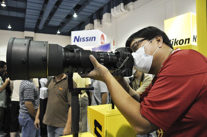 A Visitor Testing Nikon S Camera And Lens Editorial Photography - Image ...
