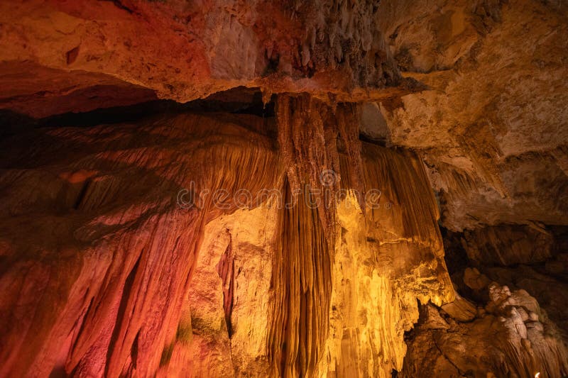 Visitors Marvel at Impressive Rock Formations in a Limestone Cave ...