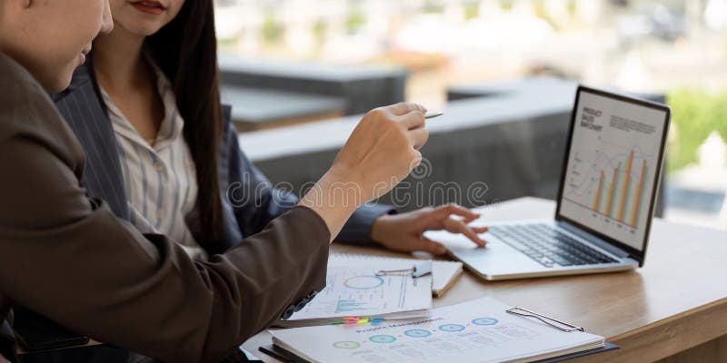 Visual Presentation. Two Professionals Reviewing Data and Insights on a ...