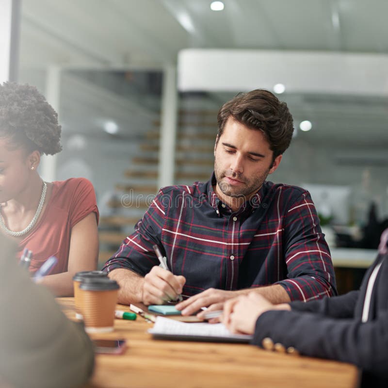 Visualising Plans on Paper. Young Creatives Working in an Office. Stock ...