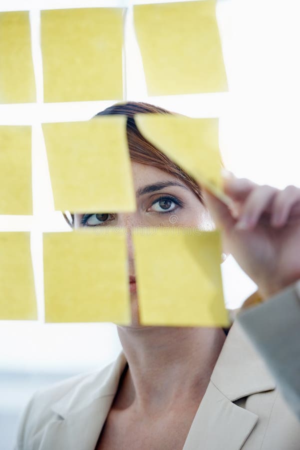 Visualizing Her Thoughts. a Businesswoman Arranging Sticky Notes on a ...