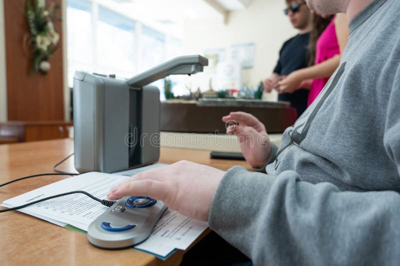 A Visually Impaired Man Uses a Scanning and Reading Machine. Stock ...