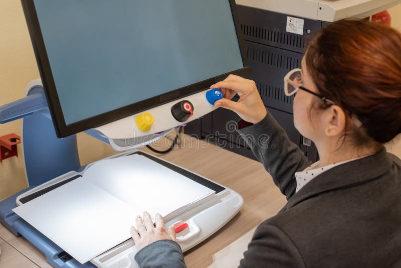 A Visually Impaired Woman Uses Special Reading Equipment Stock Photo ...