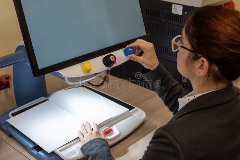 A Visually Impaired Woman Uses Special Reading Equipment Stock Photo ...