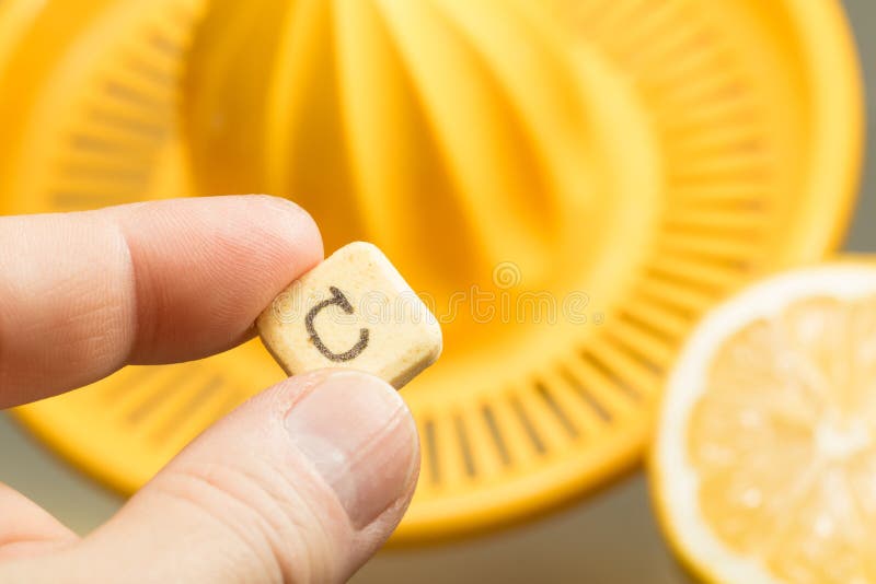 Vitamin C Pill between the Fingers and Fresh Lemon Stock Image - Image ...