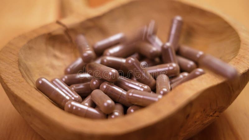 Vitamin Nutritional Supplement Capsules Falling into a Wooden Rustic ...