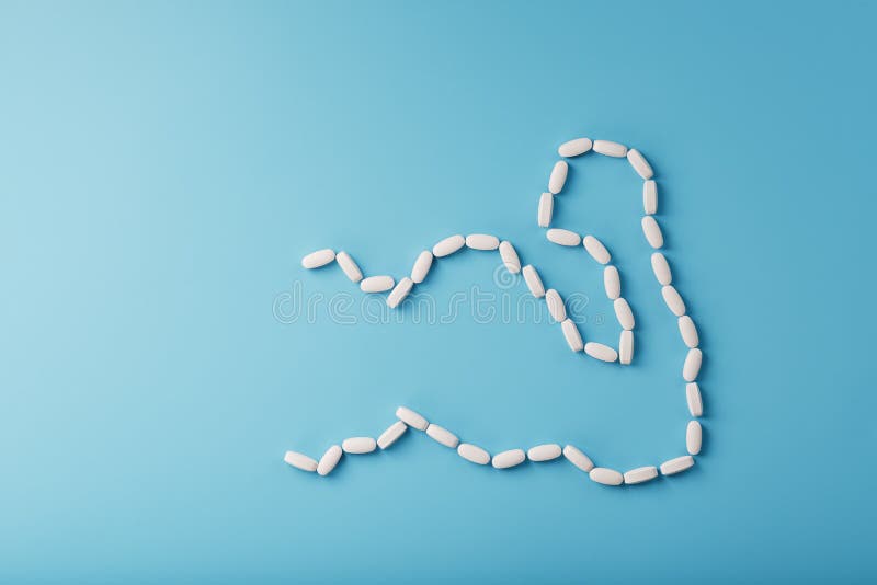 Vitamins in the Form of Biceps Muscles on a Blue Background Stock Photo ...