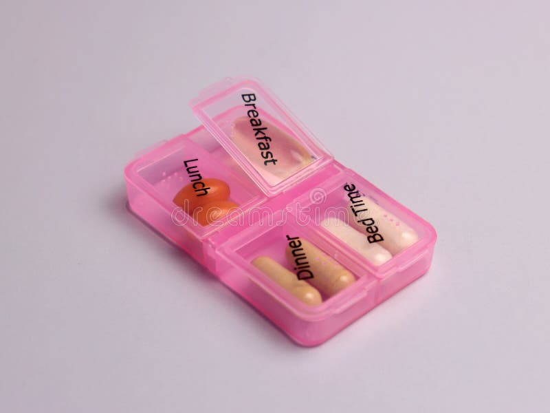 Vitamins in a Pink Box with a Timetable for Taking on a Pale Lilac ...