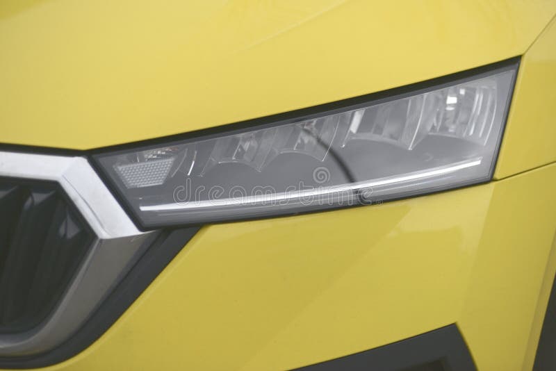 Modern LED Headlight Close-Up on Yellow Car with Sharp Geometric ...