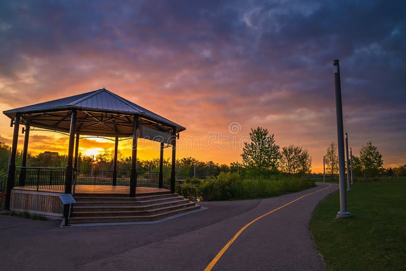 Vivid Cloudy Sunrise Over a Park Pathway Stock Photo - Image of park ...