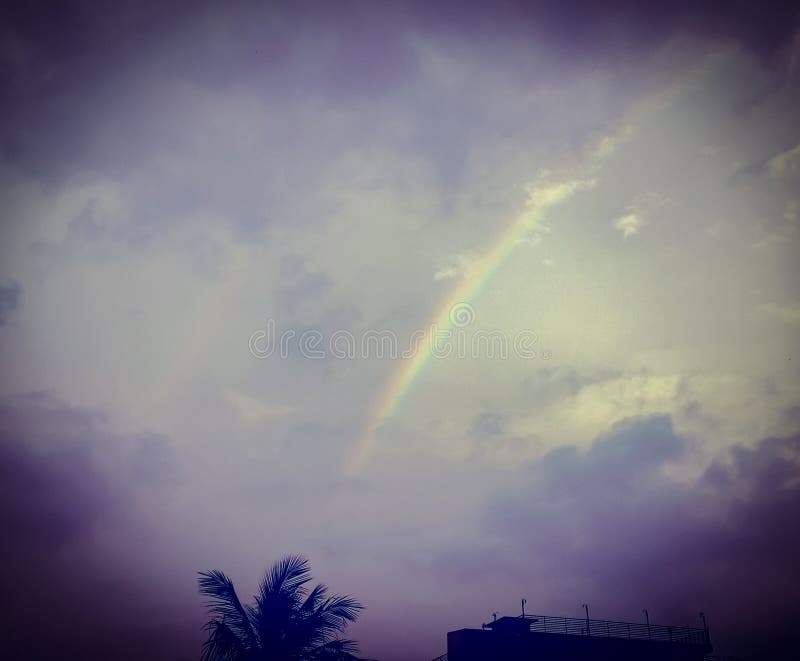 Vivid Rainbow with Dark Blue Cloud Around it. Beautiful Rainbow after ...