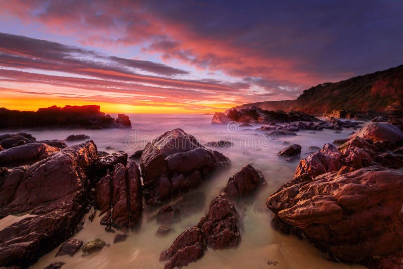 Vivid Red Sunrise Over Rocky Beach Coast Stock Photo - Image of ...