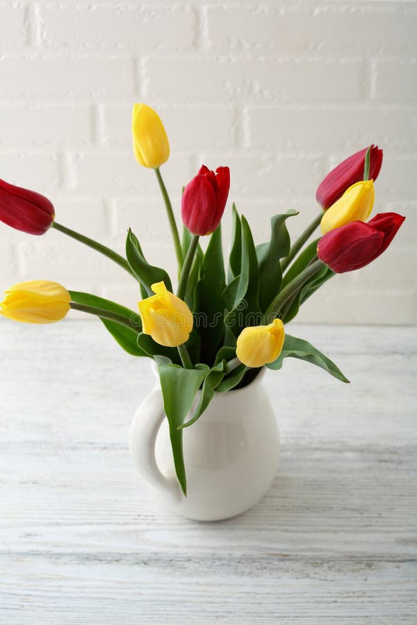 Vivid tulips in white jug stock photo. Image of springtime - 75531378