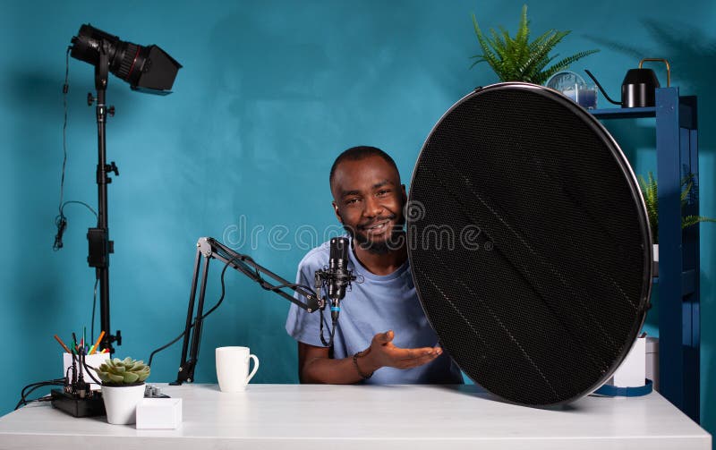 Vlogger Explaining Features of Studio Flash Light Modifier Sitting at ...