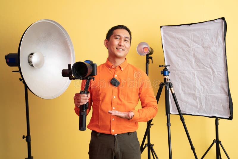 Vlogger with Hand Gesture Presenting while Holding Camera with ...