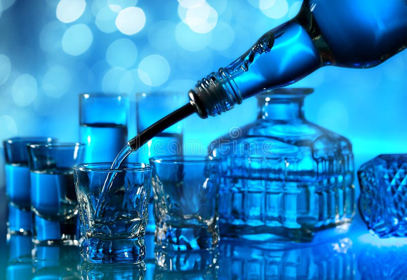 Vodka on glass table stock image. Image of bottle, neat - 47809129