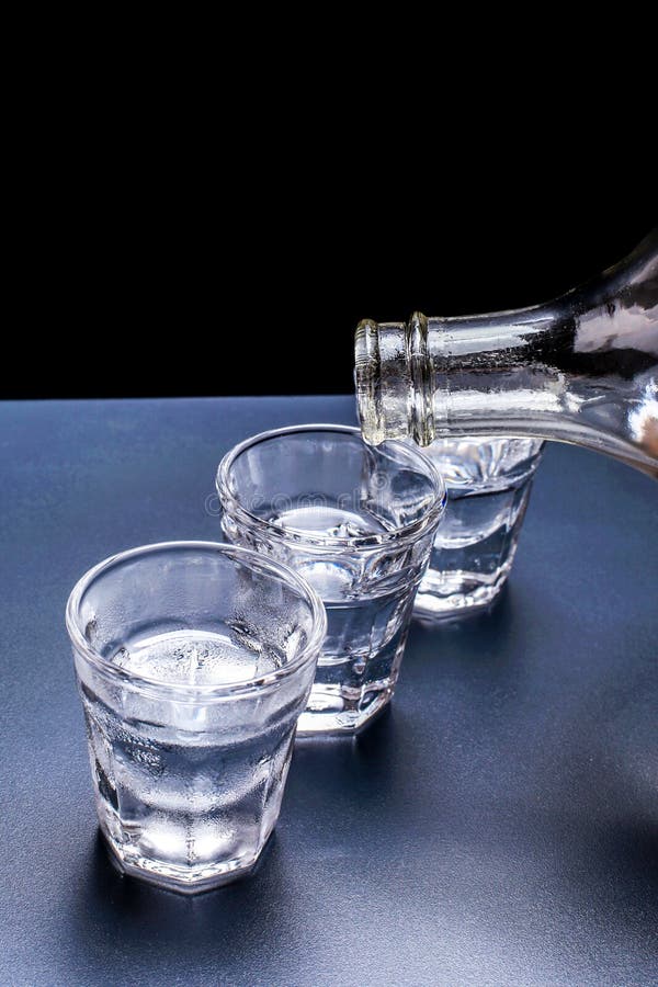 Vodka glasses on the table stock photo. Image of liquid - 66347656