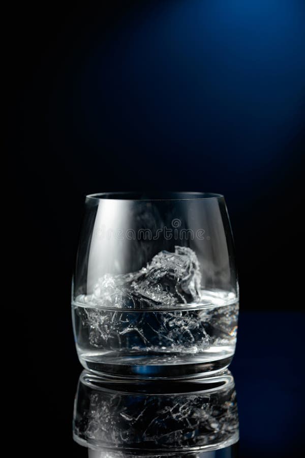 Vodka with Ice on a Black Reflective Background Stock Image - Image of ...