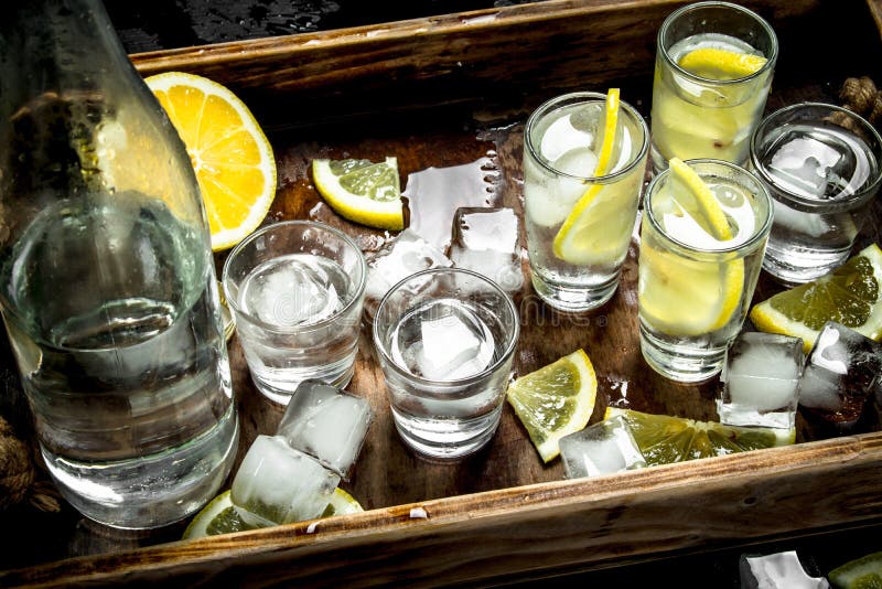 Vodka with Lemon and Ice on a Wooden Tray. Stock Photo - Image of ...