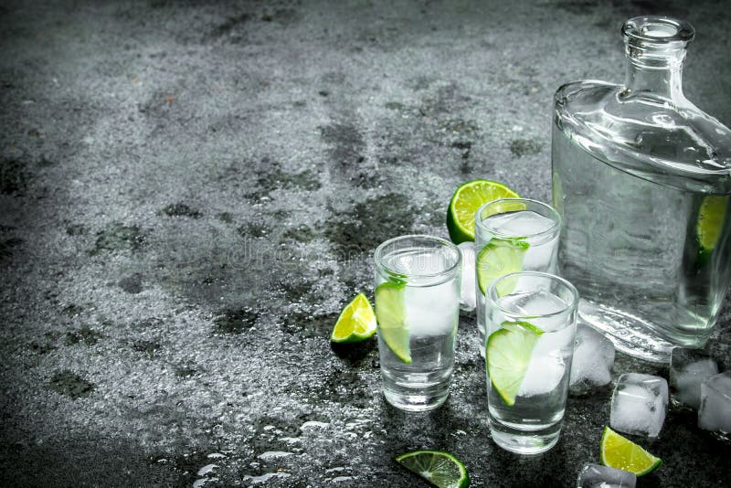 Vodka with Pieces of Lime and Ice Cubes. Stock Image - Image of alcohol ...