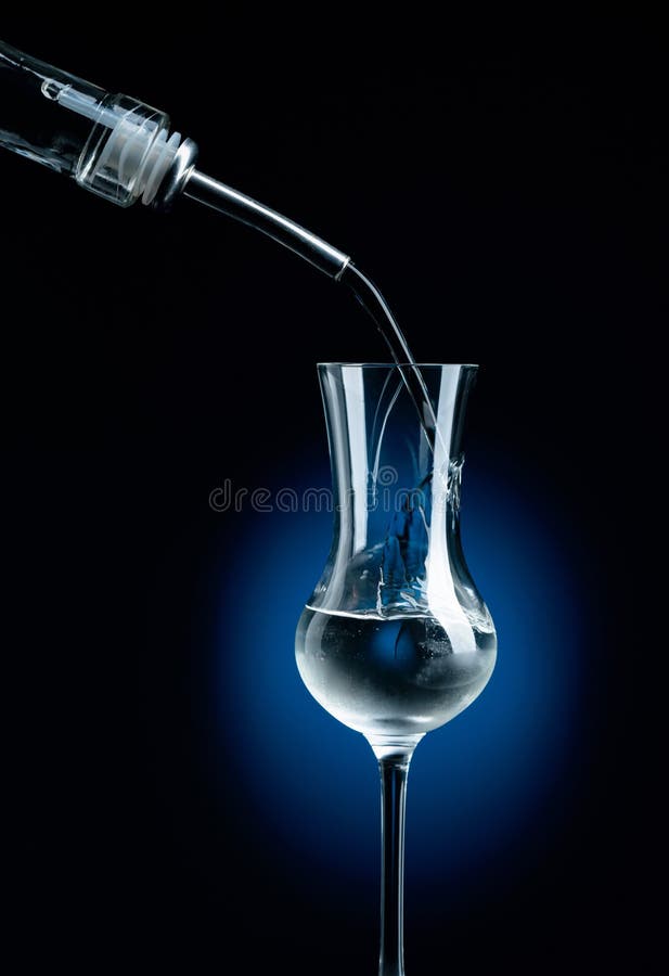 Vodka is Poured from Bottle into Glass with Ice Stock Image - Image of ...