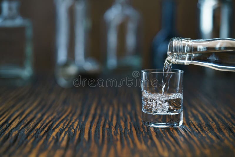 Vodka Pouring from the Bottle into Glass in a Bar, Selective Fo Stock ...