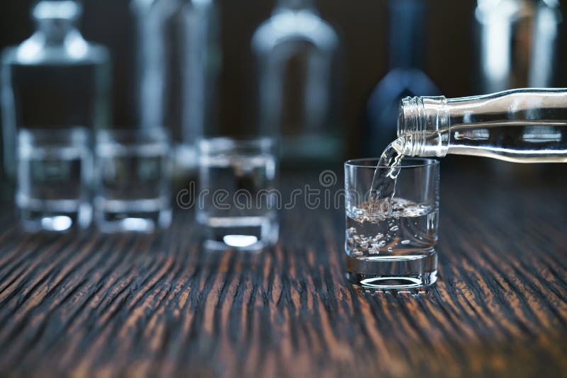 Vodka Pouring from the Bottle into Glass in a Bar, Selective Fo Stock ...