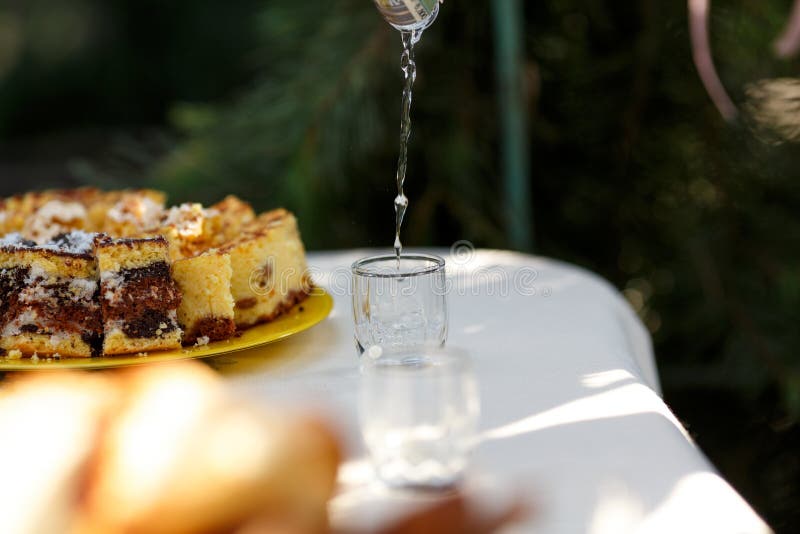 Vodka Pours from a Bottle in a Shot Standing on the White Table Stock ...