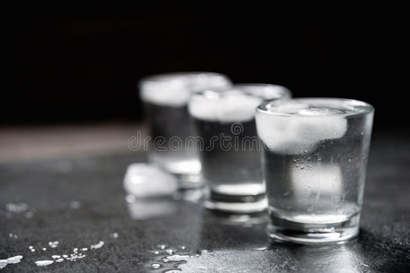 Vodka Shots with Ice Cubes on Black Stone, Stock Image - Image of blue ...