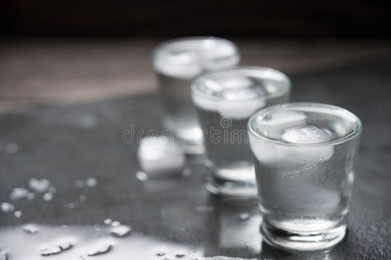 Vodka Shots with Ice Cubes on Black Stone, Stock Image - Image of clear ...