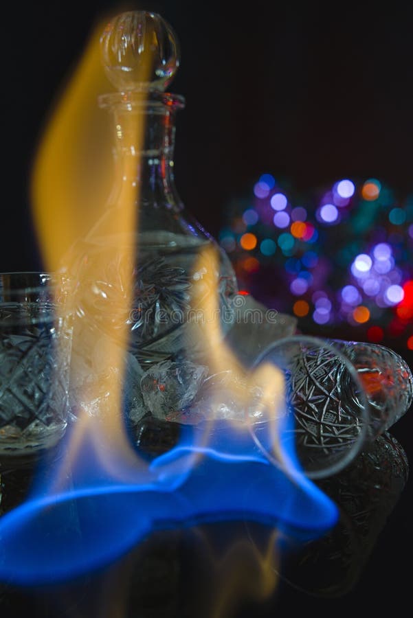 Vodka Spilled on the Table Burns with a Blue Flame. a Crystal Decanter ...