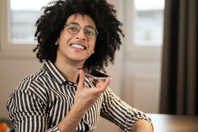 Young Man in Striped Shirt Recording a Voice Message Stock Image ...