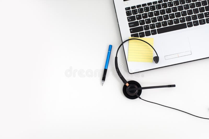 VOIP Headset, Note Paper and Pen on Laptop Computer Keyboard ...