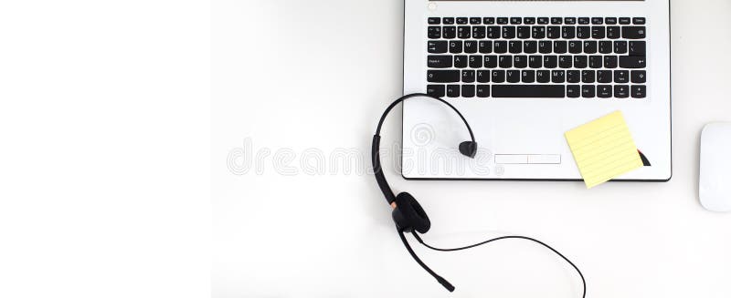 VOIP Headset, Note Paper and Pen on Laptop Computer Keyboard ...