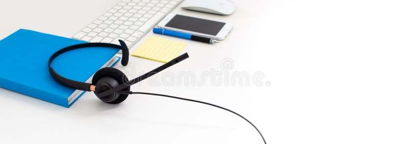 VOIP Headset, Pen and Notebook on Laptop Computer Keyboard ...